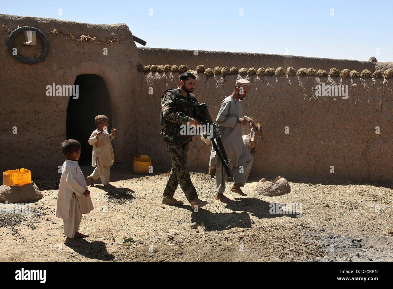 An Afghan National Army (ANA) Soldier with 215 ANA Corps, speaks with a ...