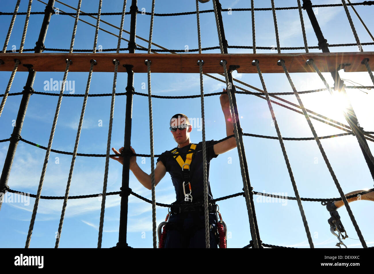 Coast Guard Barque Eagle crew member Seaman Joel Sprowls climbs down ...