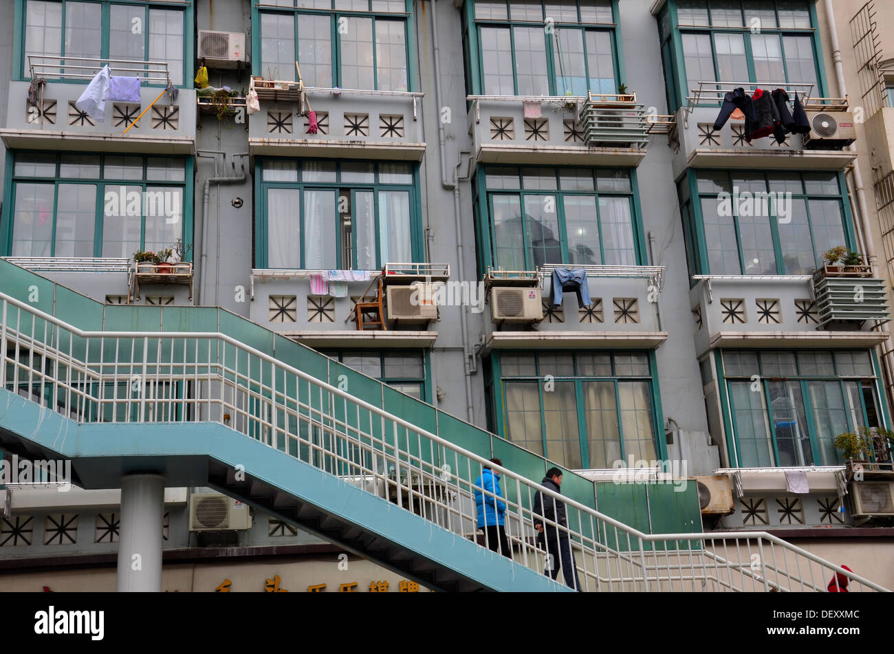 Chinese Pedestrians on steps outside apartment block Shanghai China ...