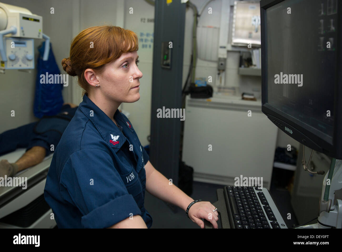 Hospital Corpsman 2nd Class Christin York views an x-ray of a patient's ...