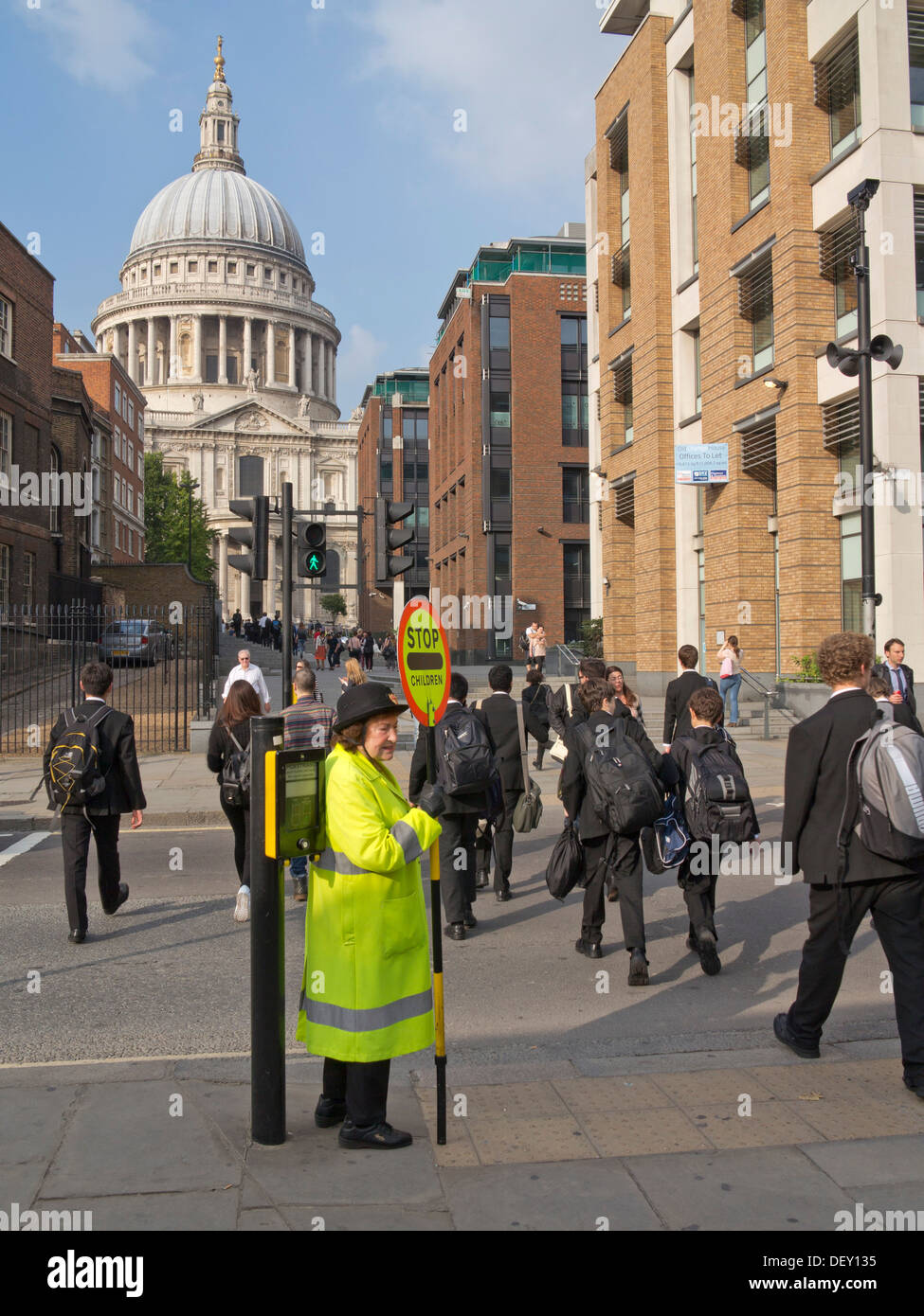 Lollipop lady assisting City of London school students near St. Paul's ...