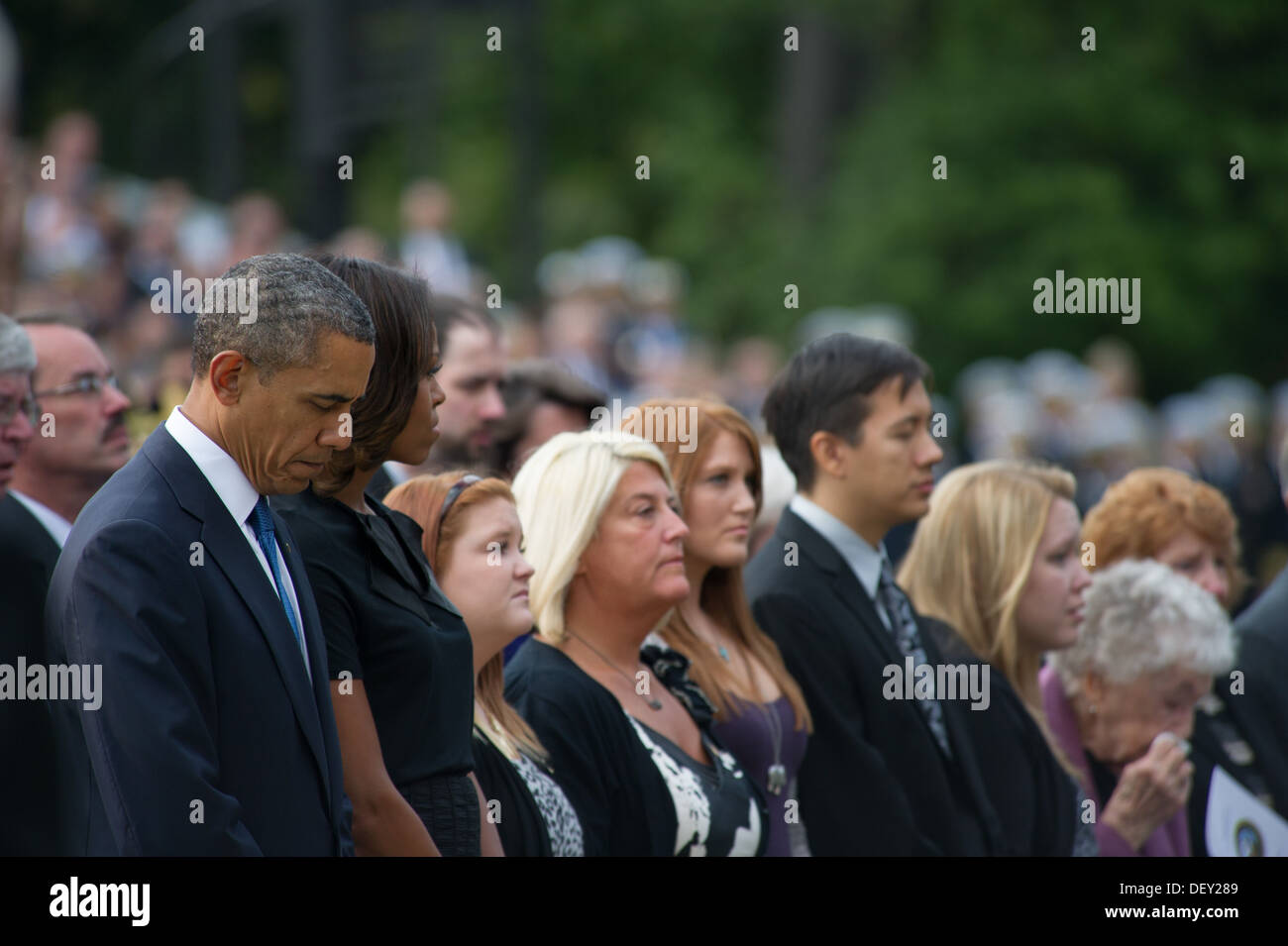 U.S. President Barack H. Obama bows his head during a memorial for ...