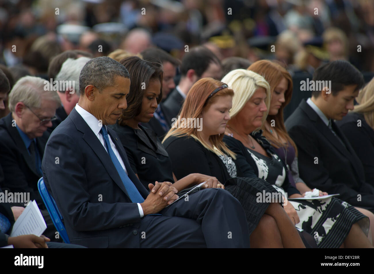 U.S. President Barack H. Obama bows his head during a memorial for ...