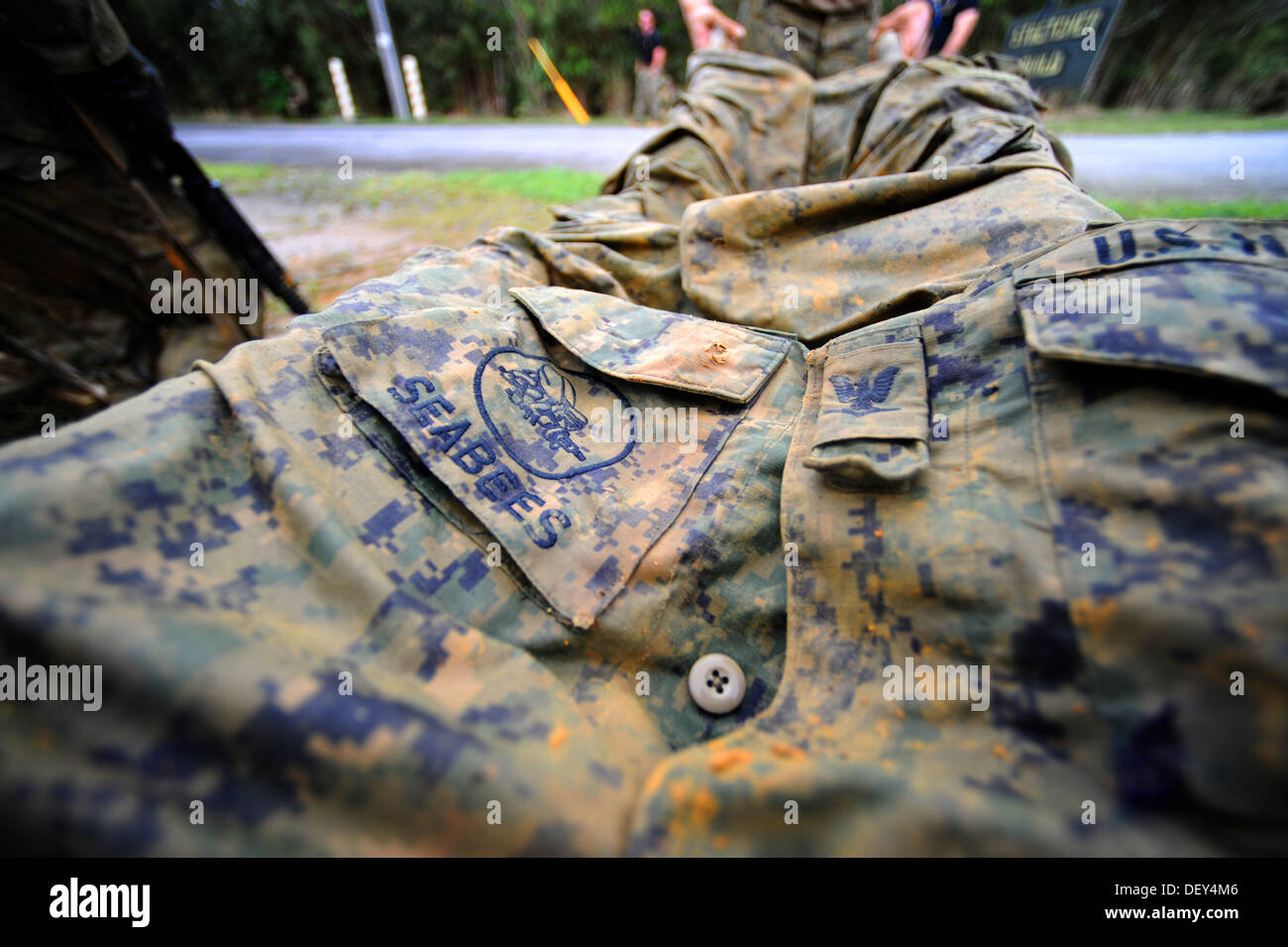 Seabees from Naval Mobile Construction Battalion (NMCB) 3 carry a mock ...