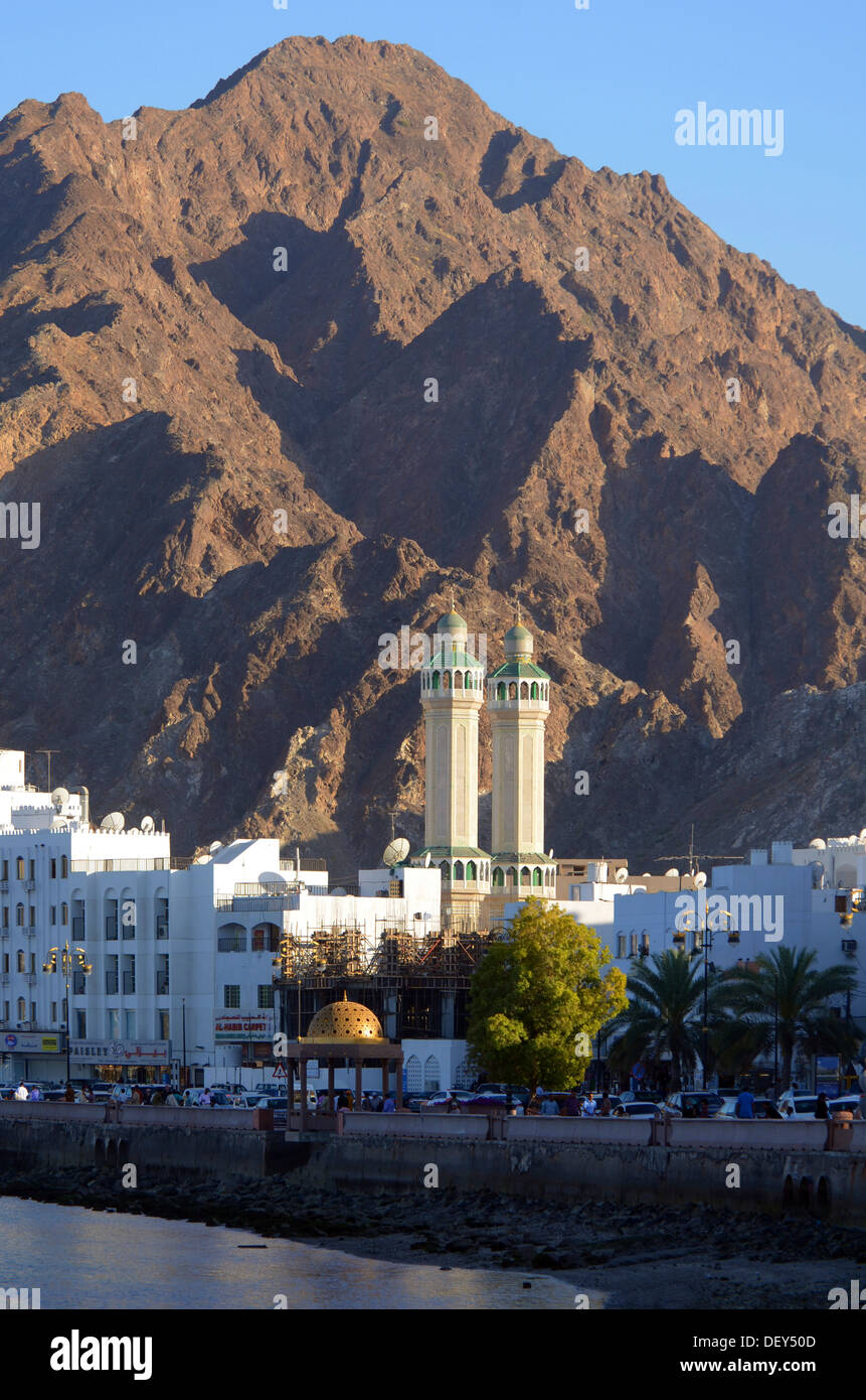 The corniche of Muttrah in front of the rocky mountains that surround ...