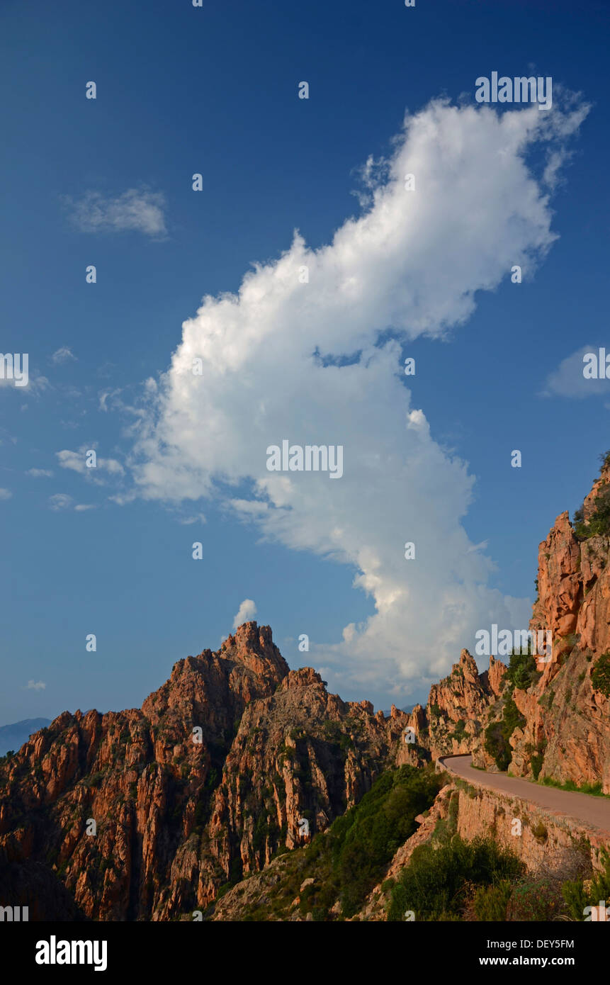 The typical bizarre red rocks of the Calanche of Piana below a blue sky ...