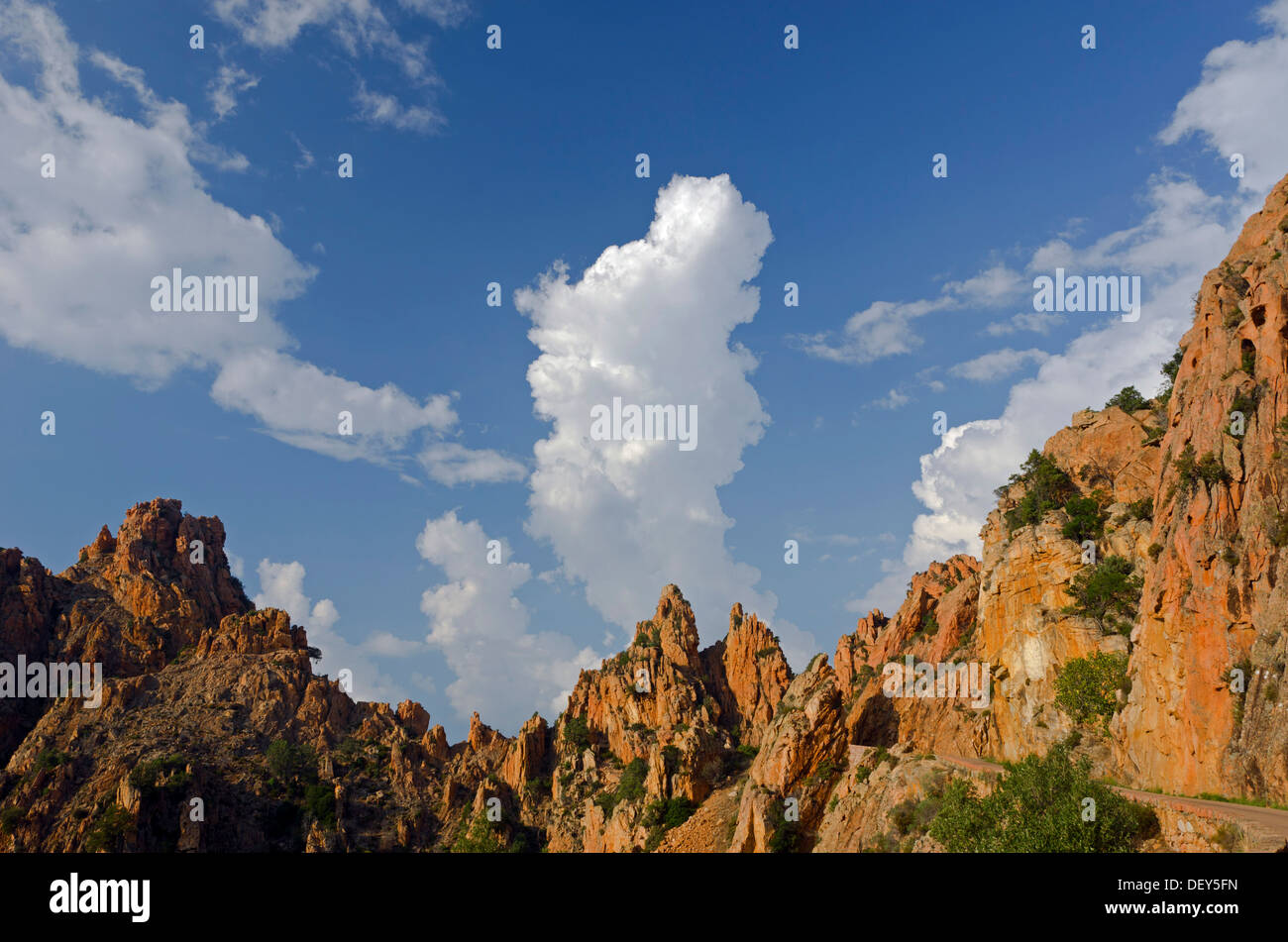 The typical bizarre red rocks of the Calanche of Piana below a blue sky ...