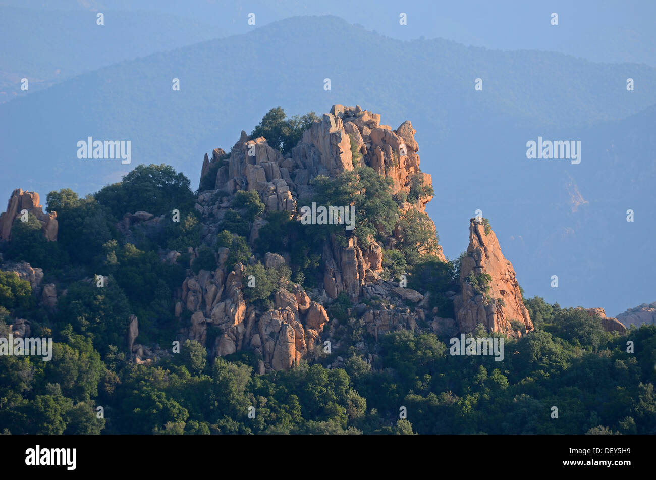 The typical bizarre red rocks of the Calanche of Piana below a blue sky ...