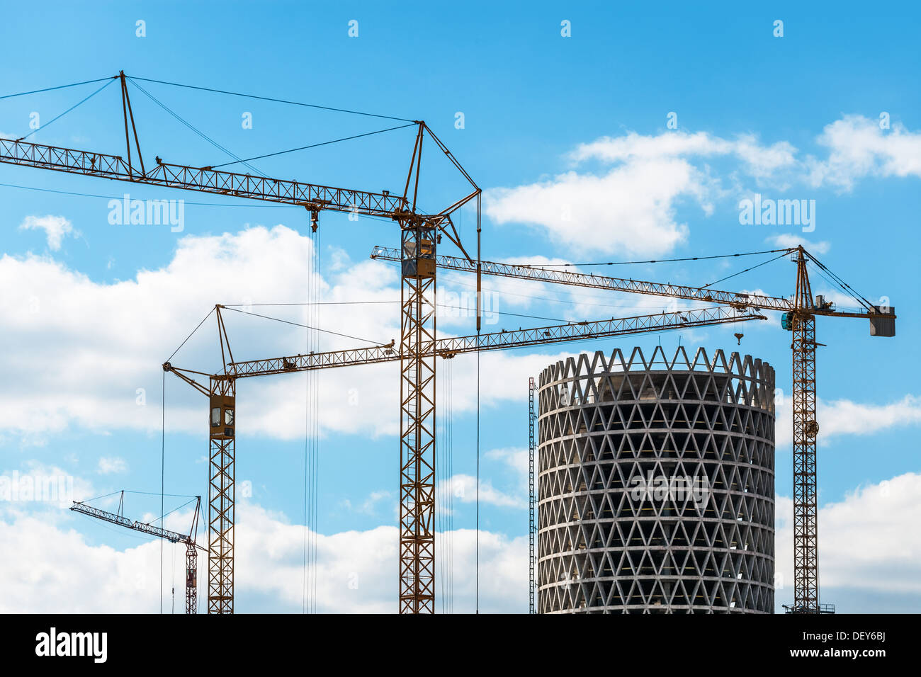 Tower cranes and building under construction Stock Photo - Alamy