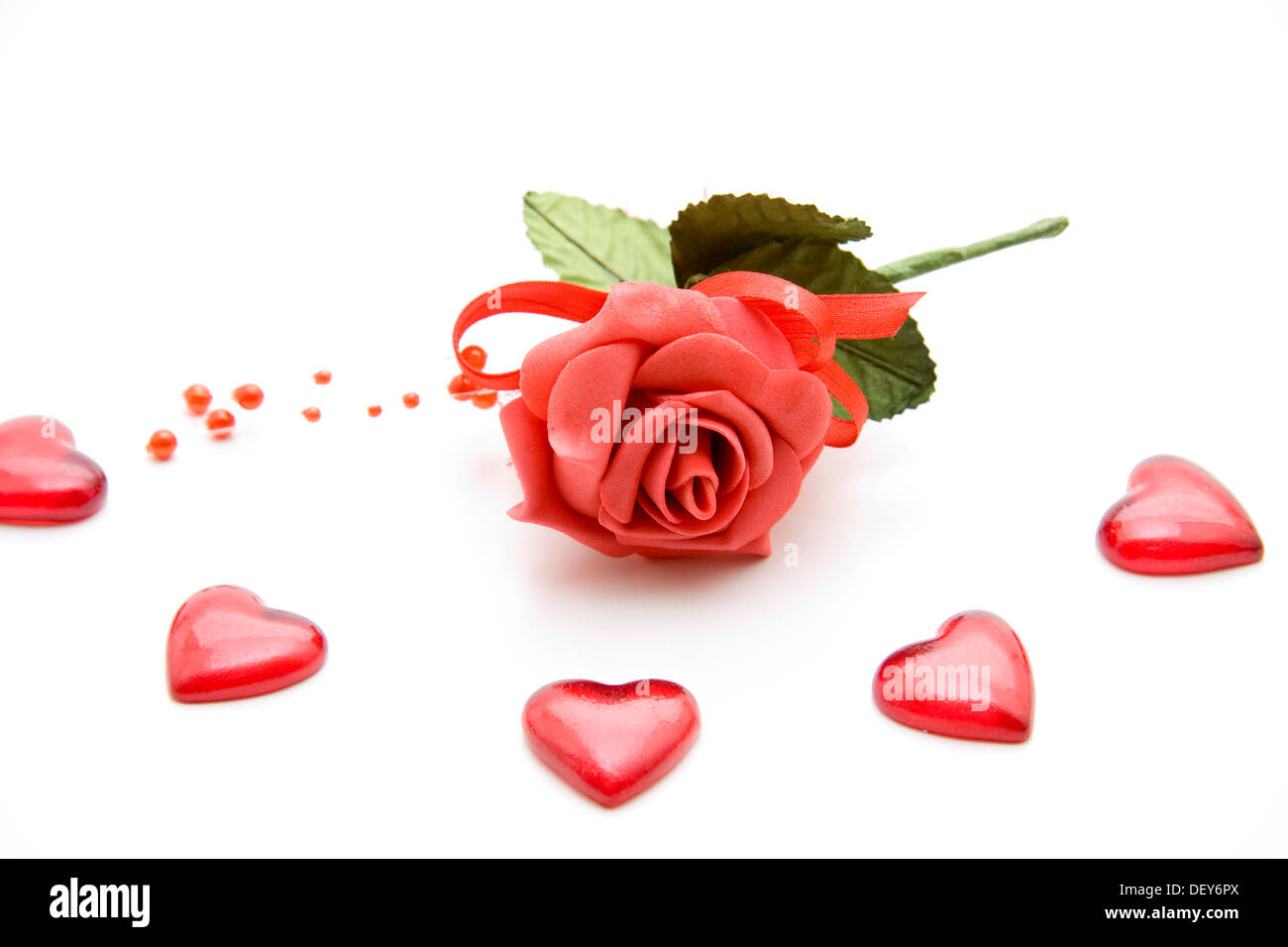 Red rose with glass hearts Stock Photo - Alamy