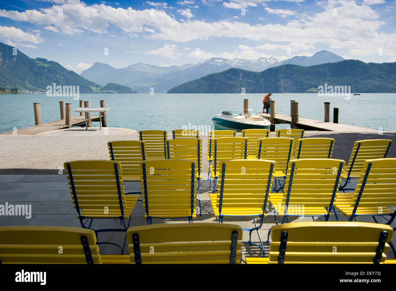 Yellow chairs standing on the lakeside promenade, Weggis, Lake Lucerne ...