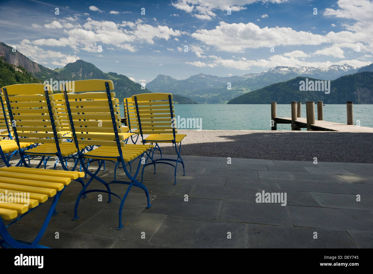 Yellow chairs standing on the lakeside promenade, Weggis, Lake Lucerne ...