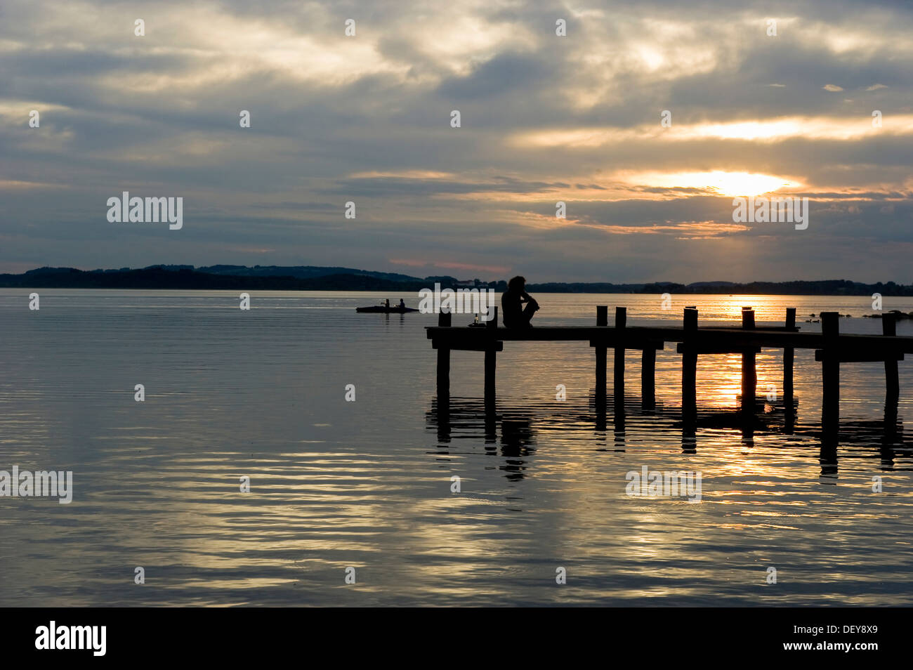 Jetty at sunset near Uebersee, Chiemsee Lake, Chiemgau region, Bavaria ...
