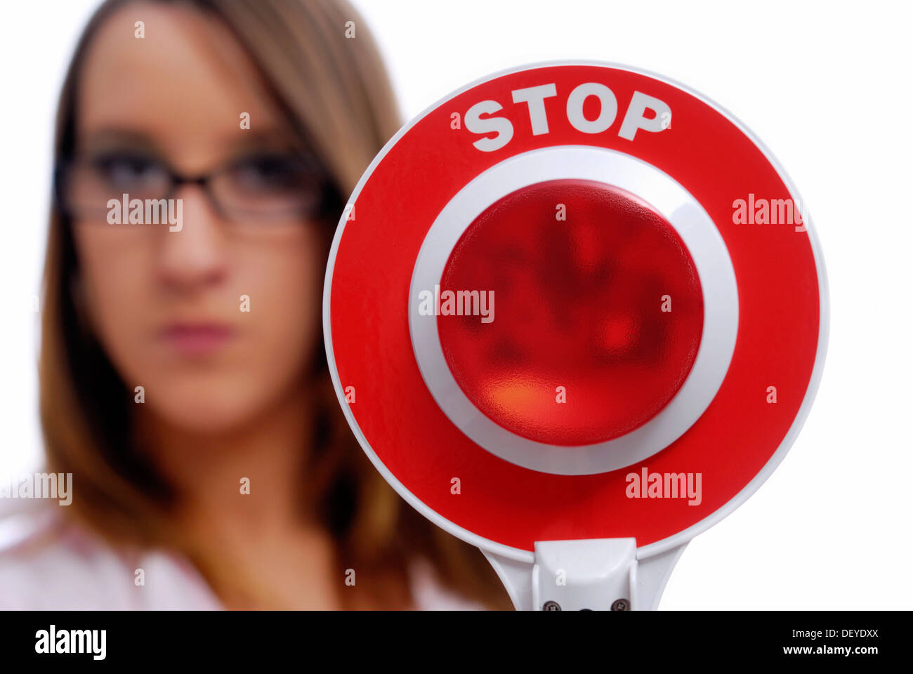 Woman holding a signalling disk, red light Stock Photo - Alamy
