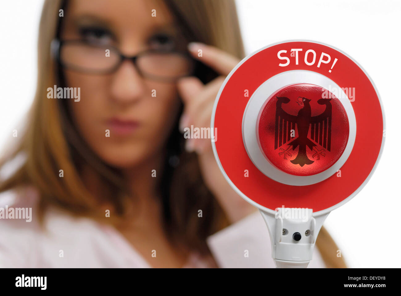 Woman holding a red police signalling disk with the federal eagle Stock ...