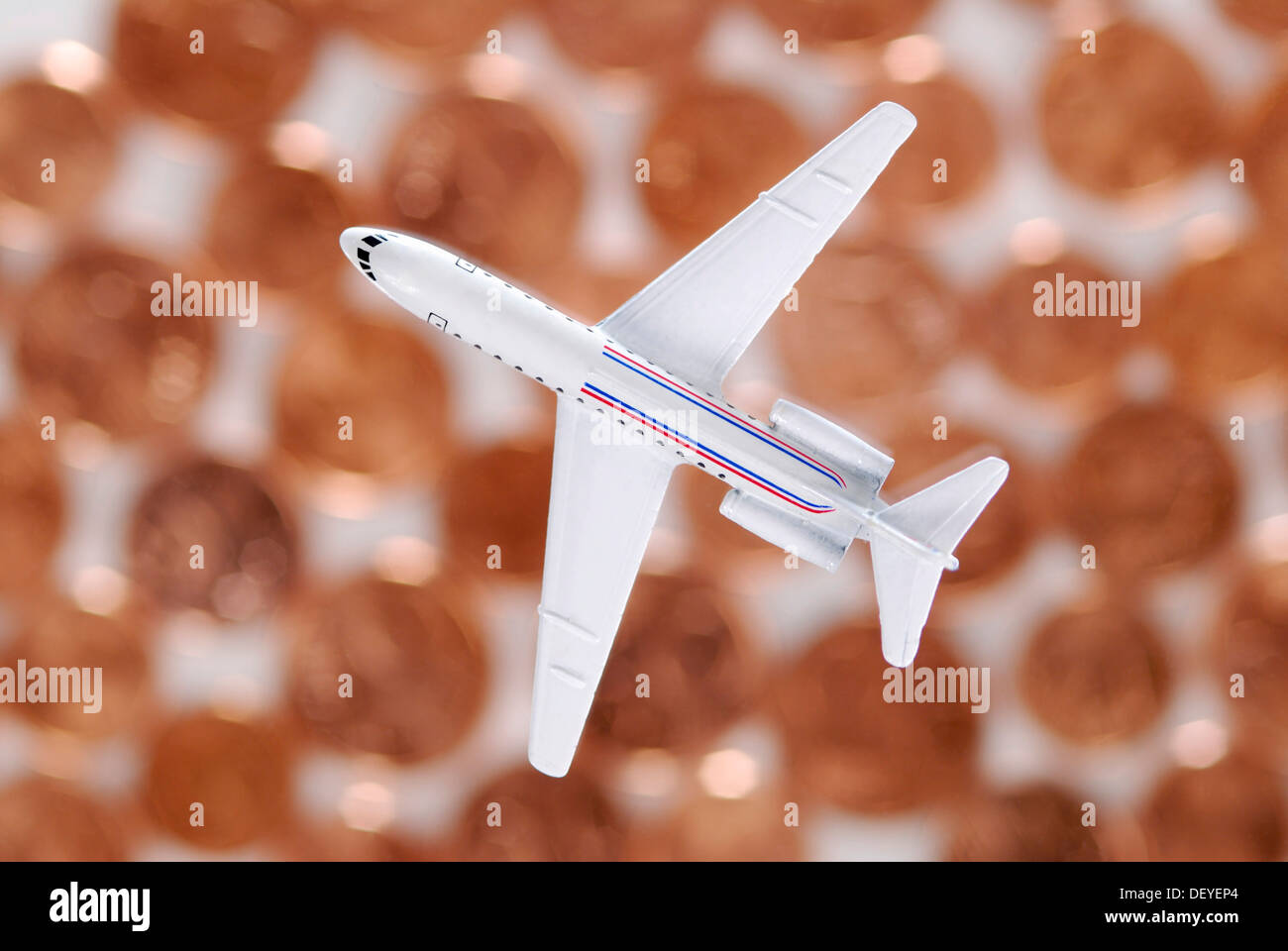 Miniature aircraft over cent coins, cheap airlines Stock Photo - Alamy