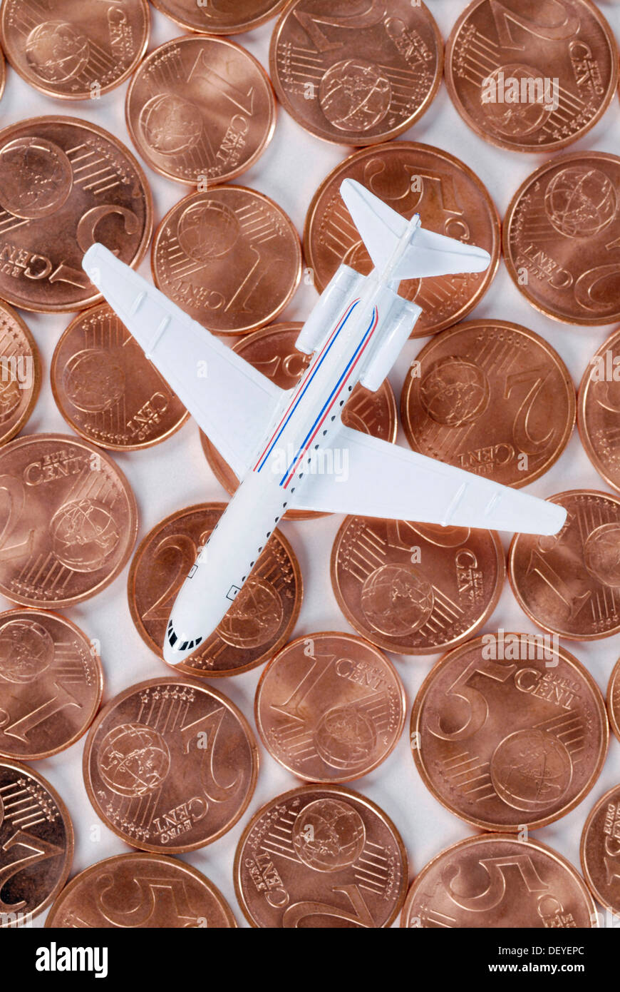 Miniature aircraft on cent coins, cheap airlines Stock Photo - Alamy