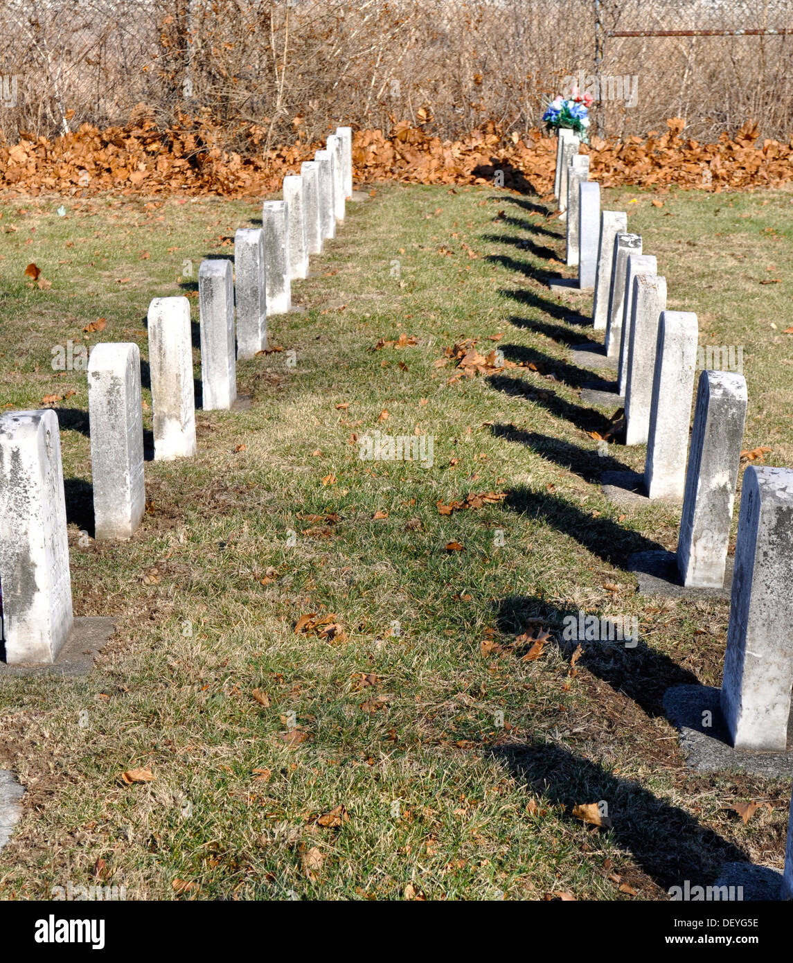 Two lines of cemetery headstones Stock Photo - Alamy