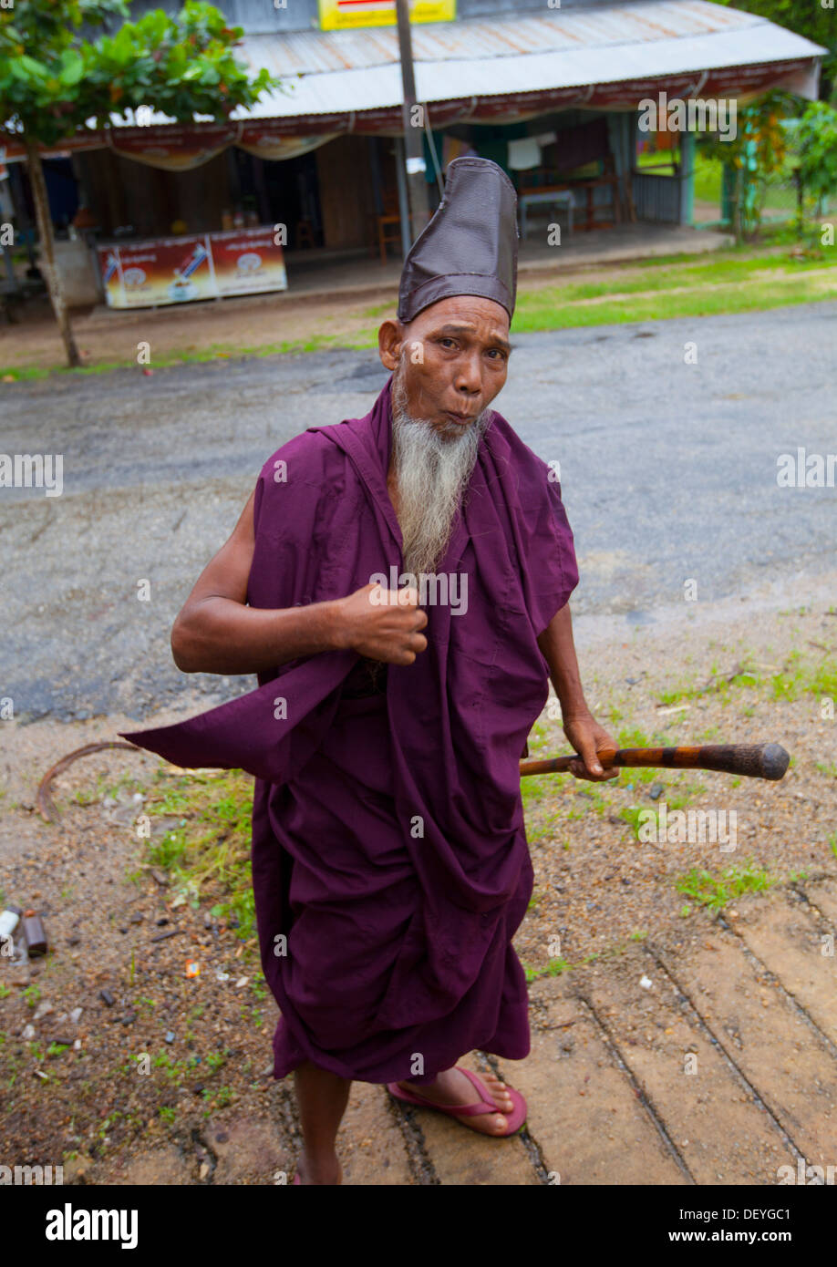 A Burmese monk with a white beard near the Golden Rock on Mt. Kyaiktiyo ...