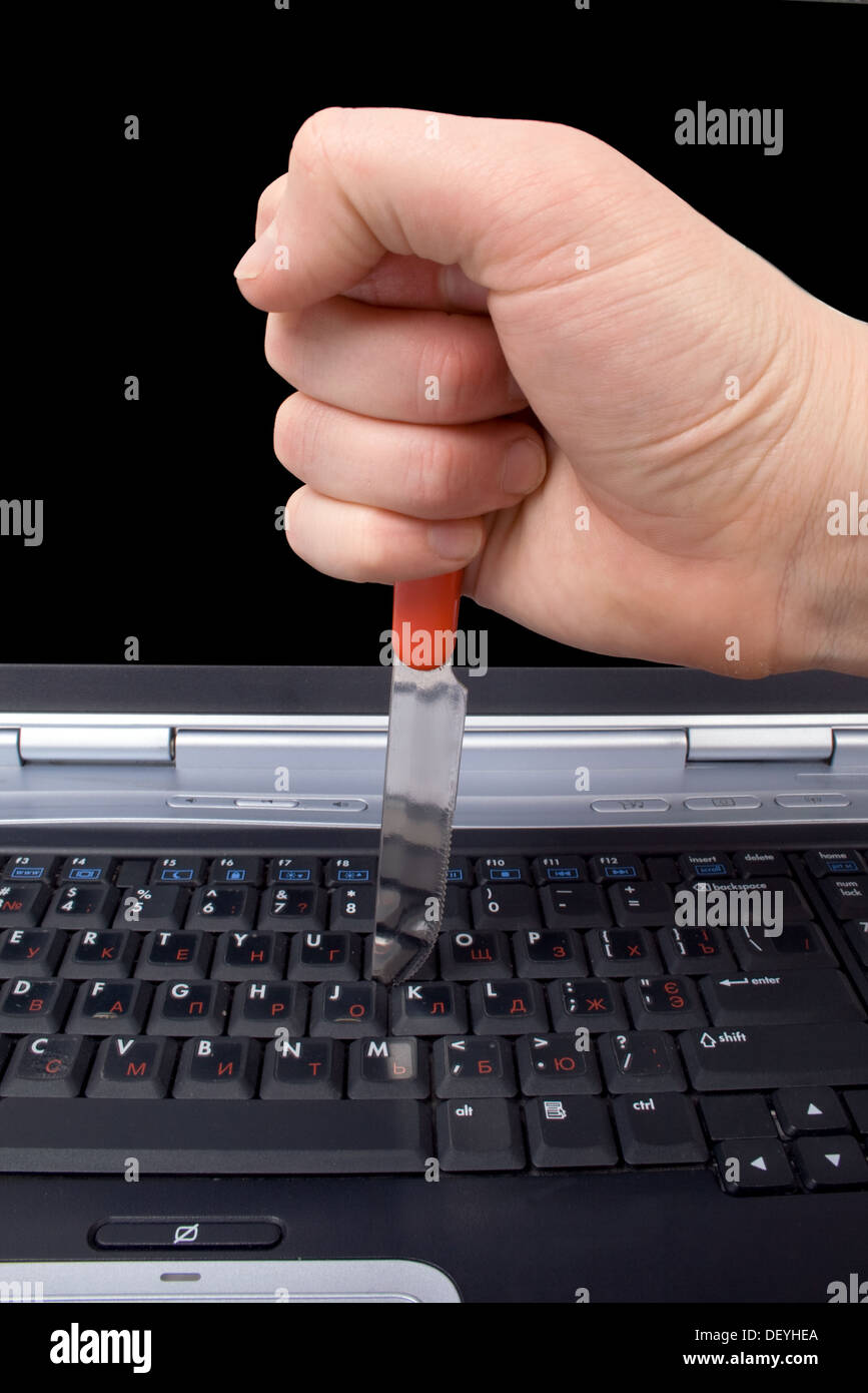 Hand with a knife in the laptop keyboard Stock Photo - Alamy