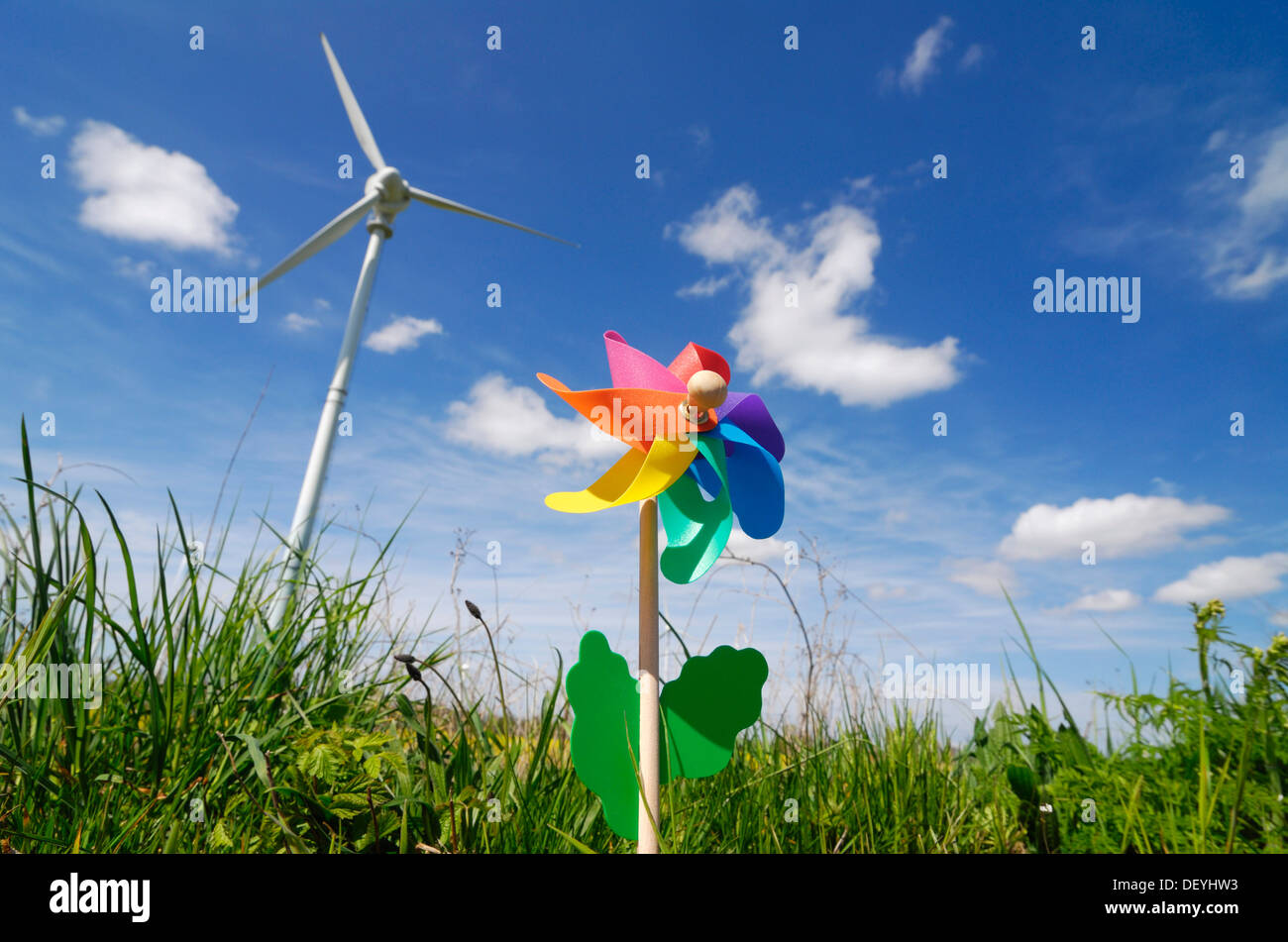 Colourful pinwheel and a wind turbine, symbolic image for wind energy ...