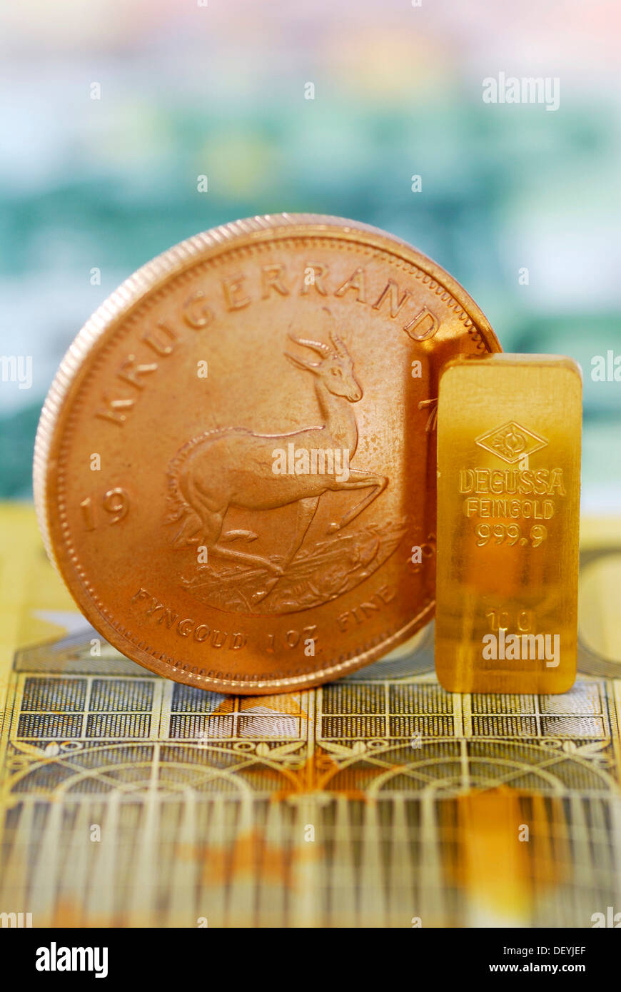 Krugerrand gold coin and bullion on euro notes, gold price Stock Photo ...