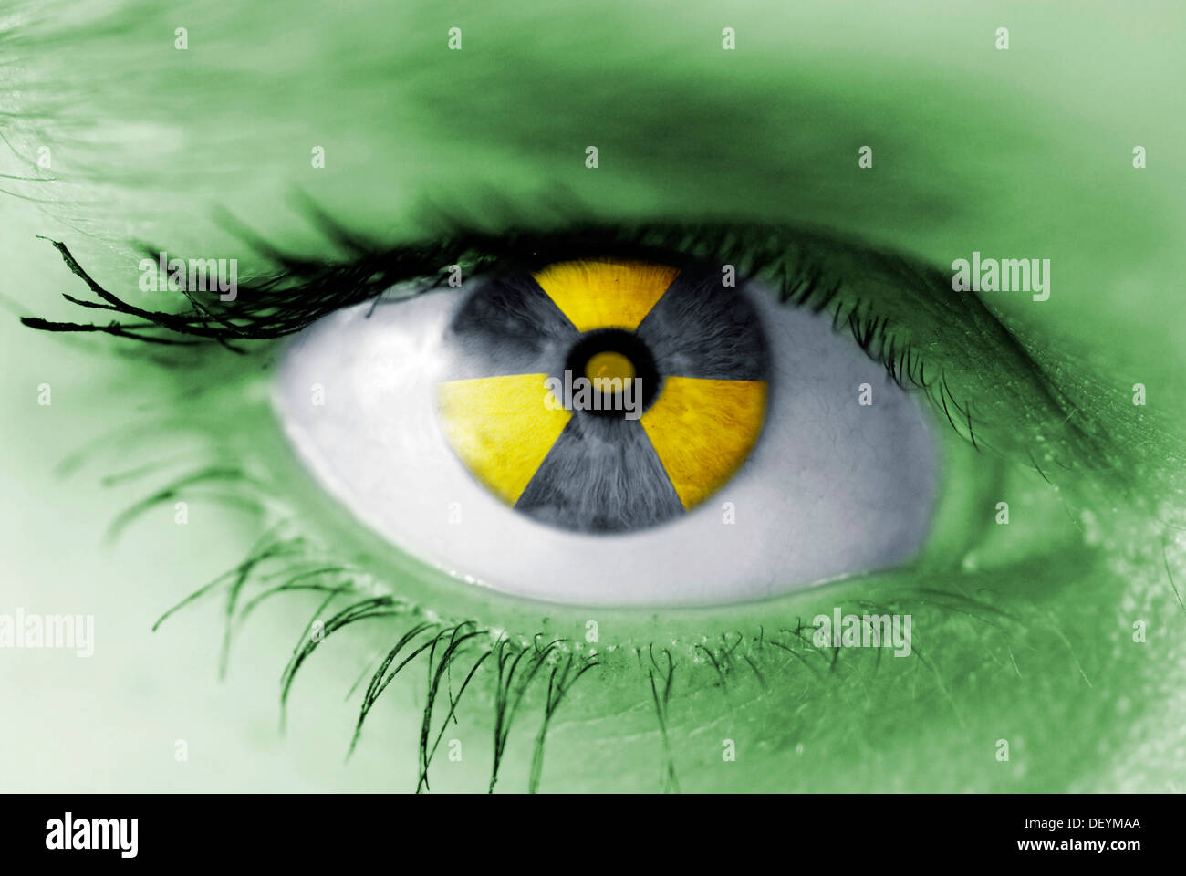 A woman's eye with a radiation warning symbol Stock Photo - Alamy