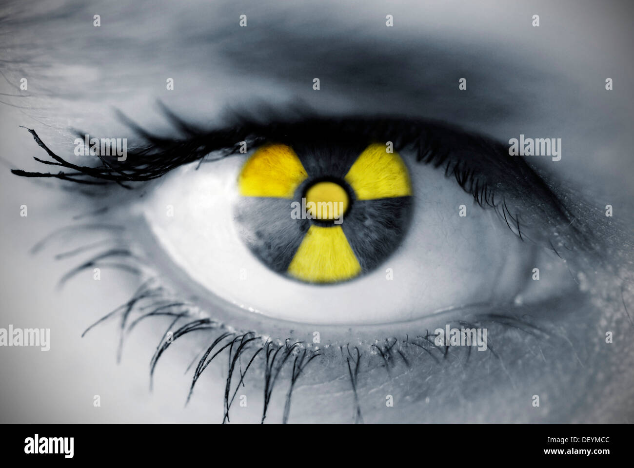 Eye of a woman with a radioactivity warning sign Stock Photo - Alamy