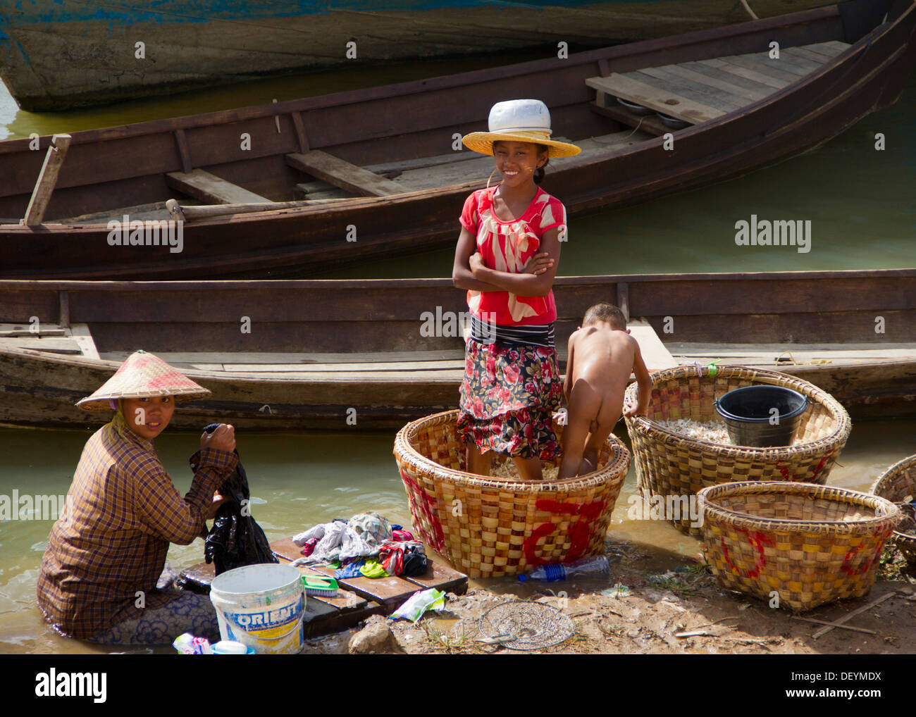 Women stomp and rinse produce on the Ayeyarwady River in Mandalay ...