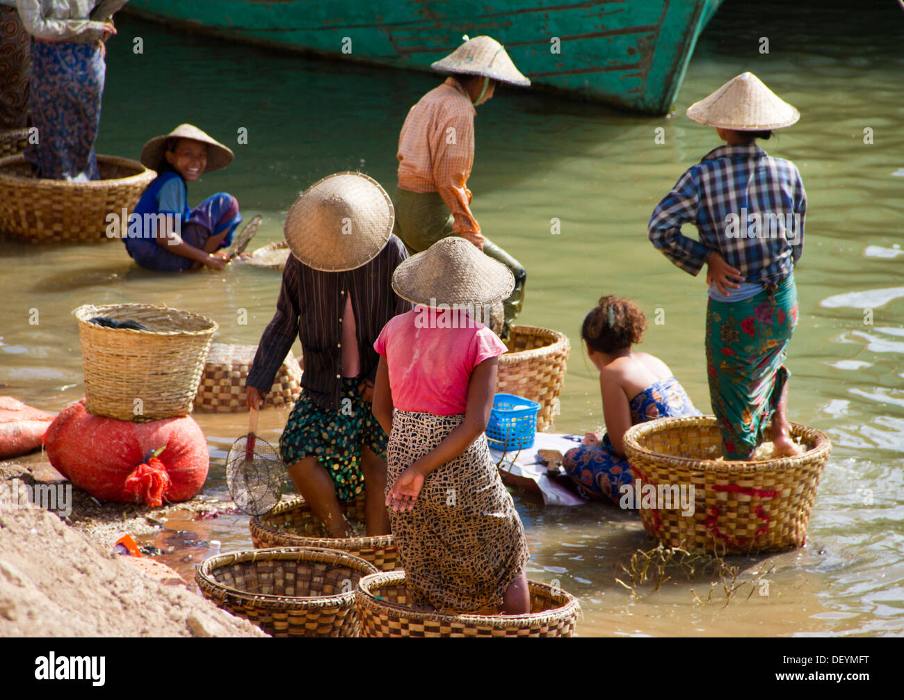 Women stomp and rinse produce on the Ayeyarwady River in Mandalay ...