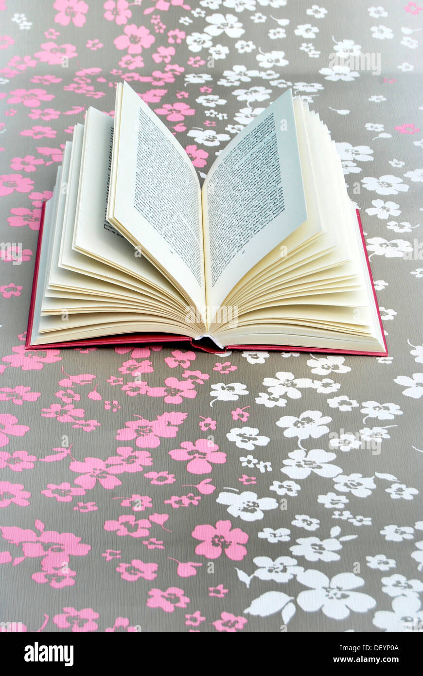 Open book on floral design Stock Photo - Alamy