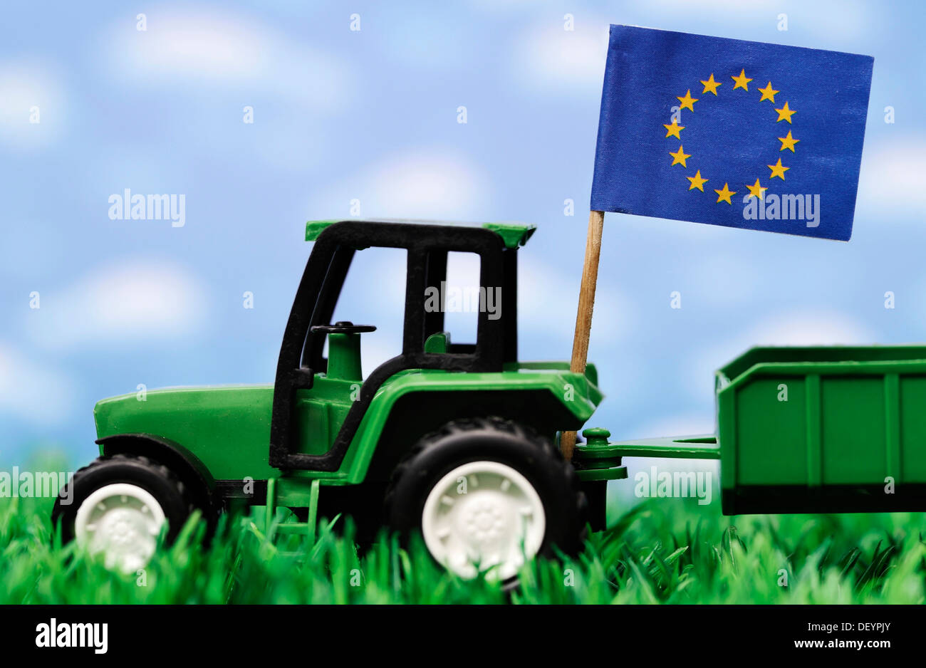 Miniature tractor with a flag of Europe, symbolic image for financial ...