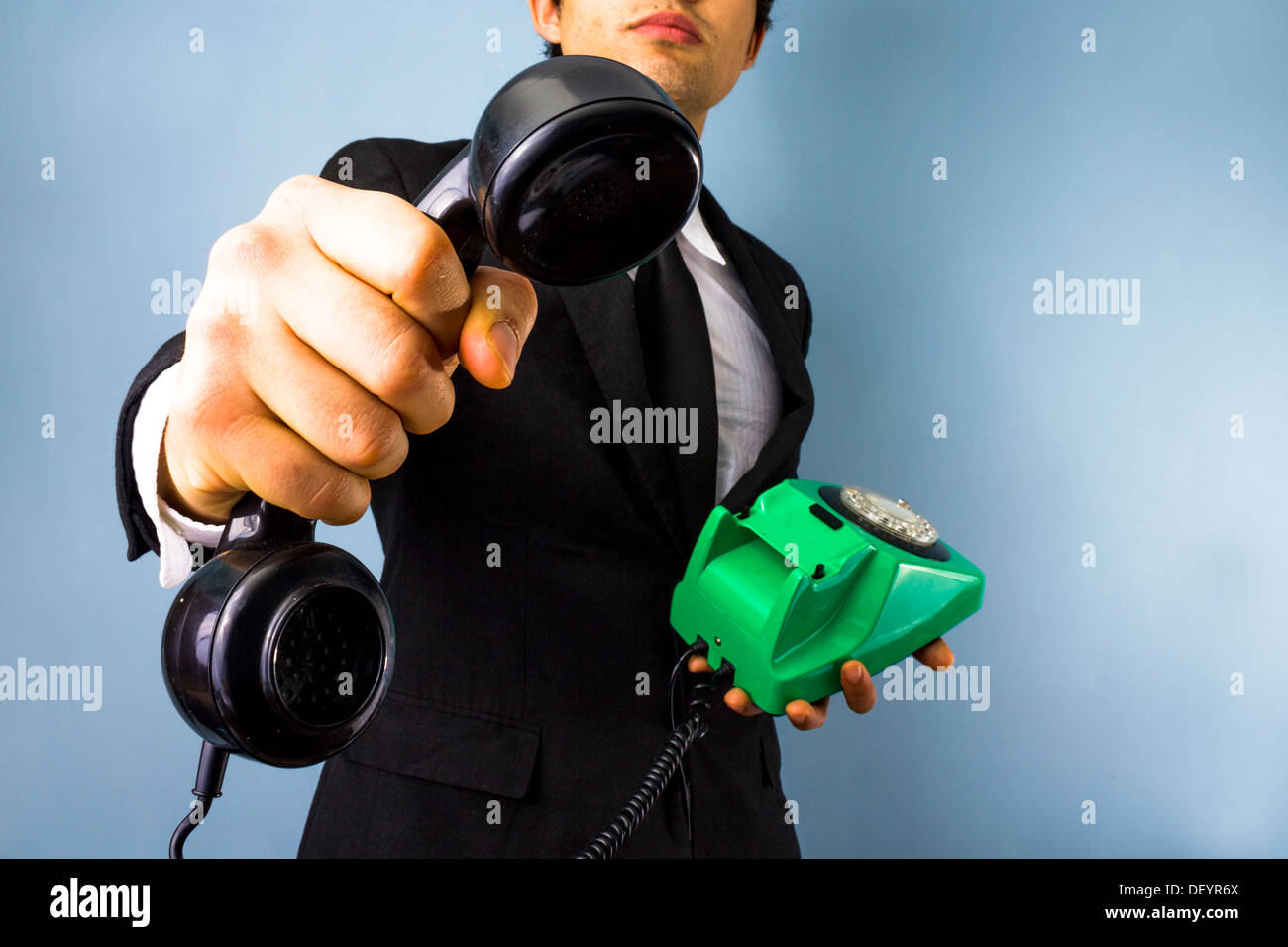 Young businessman handing over a phone Stock Photo - Alamy