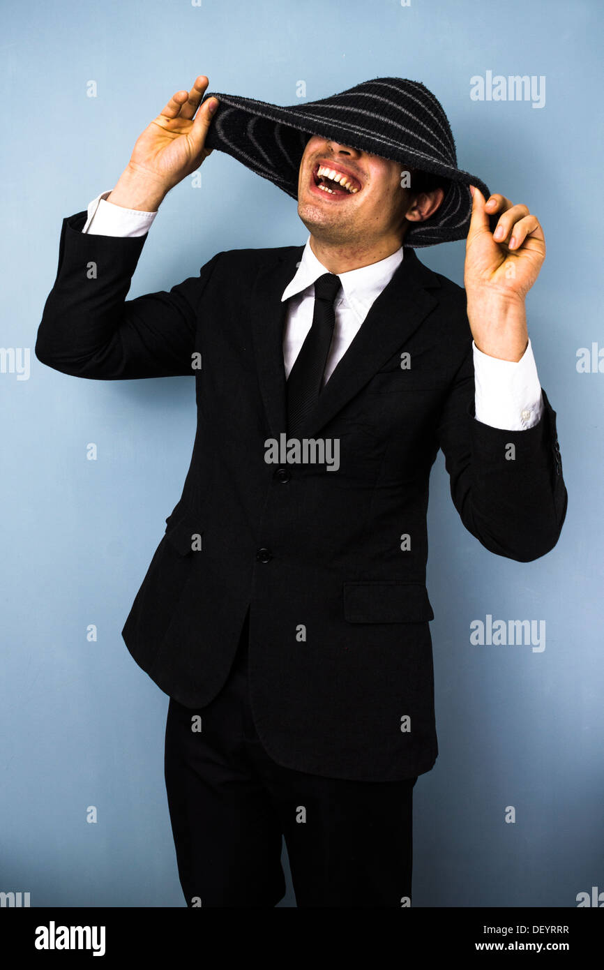 Hiding under hat hi-res stock photography and images - Alamy