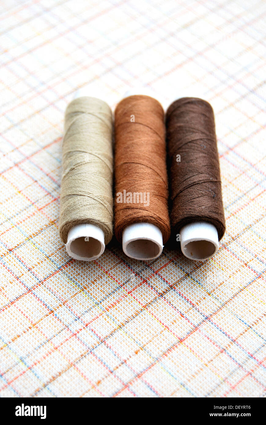 Yarn, cotton reels, spools of thread, brown, beige Stock Photo - Alamy