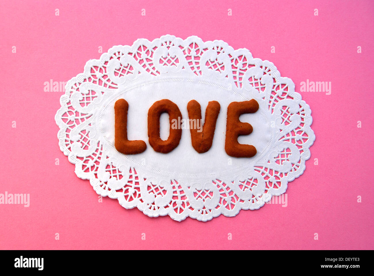 Love, lettering, alphabet biscuits on a cake lace coaster Stock Photo ...