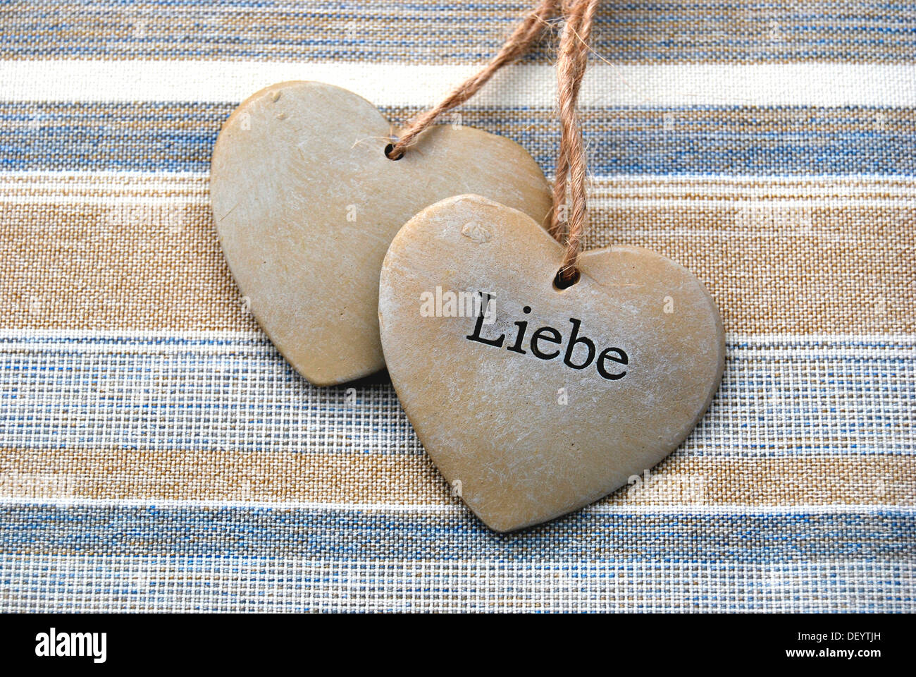 Two hearts of stone, lettering "Liebe", German for "love", symbolic ...