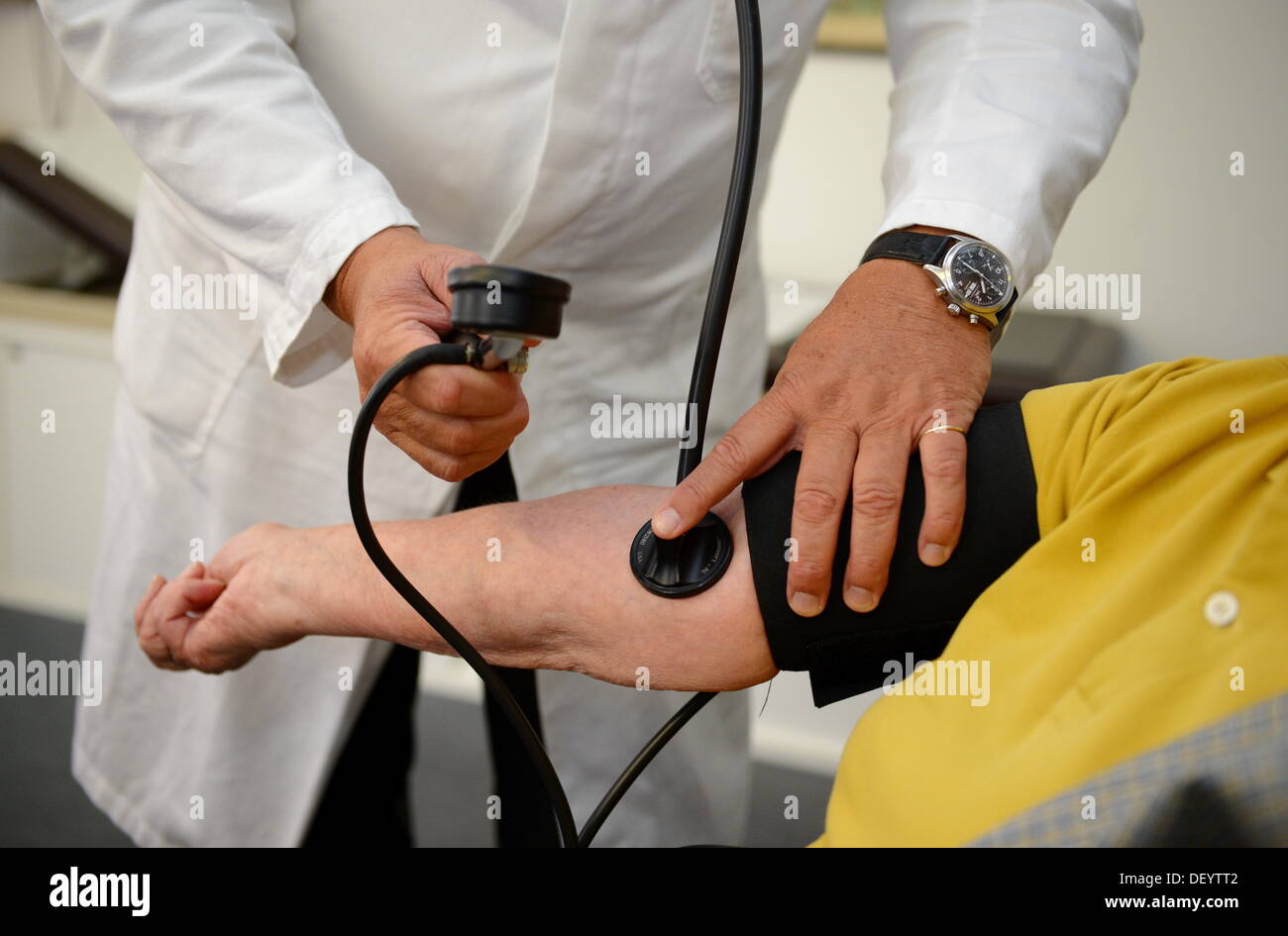 General practitioner Markus Klett examines a patient in his practice in ...