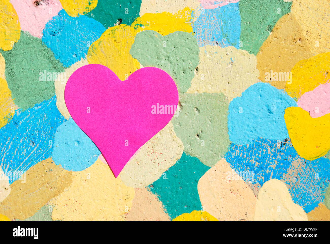Heart-shaped slip of paper on a colorfully spotted wall Stock Photo - Alamy