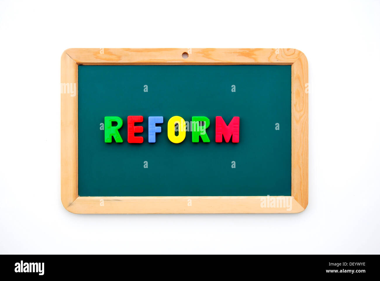 Reform, lettering, colorful magnetic letters on a black board Stock ...