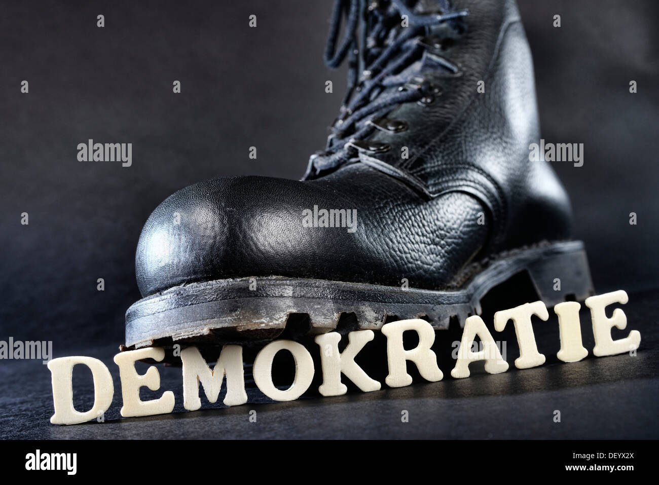 Combat boot standing on the word "Demokratie", German for "democracy ...