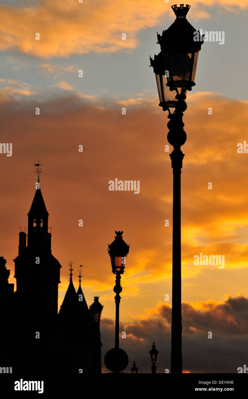 The Conciergerie and the typical Parisian street lights against ...