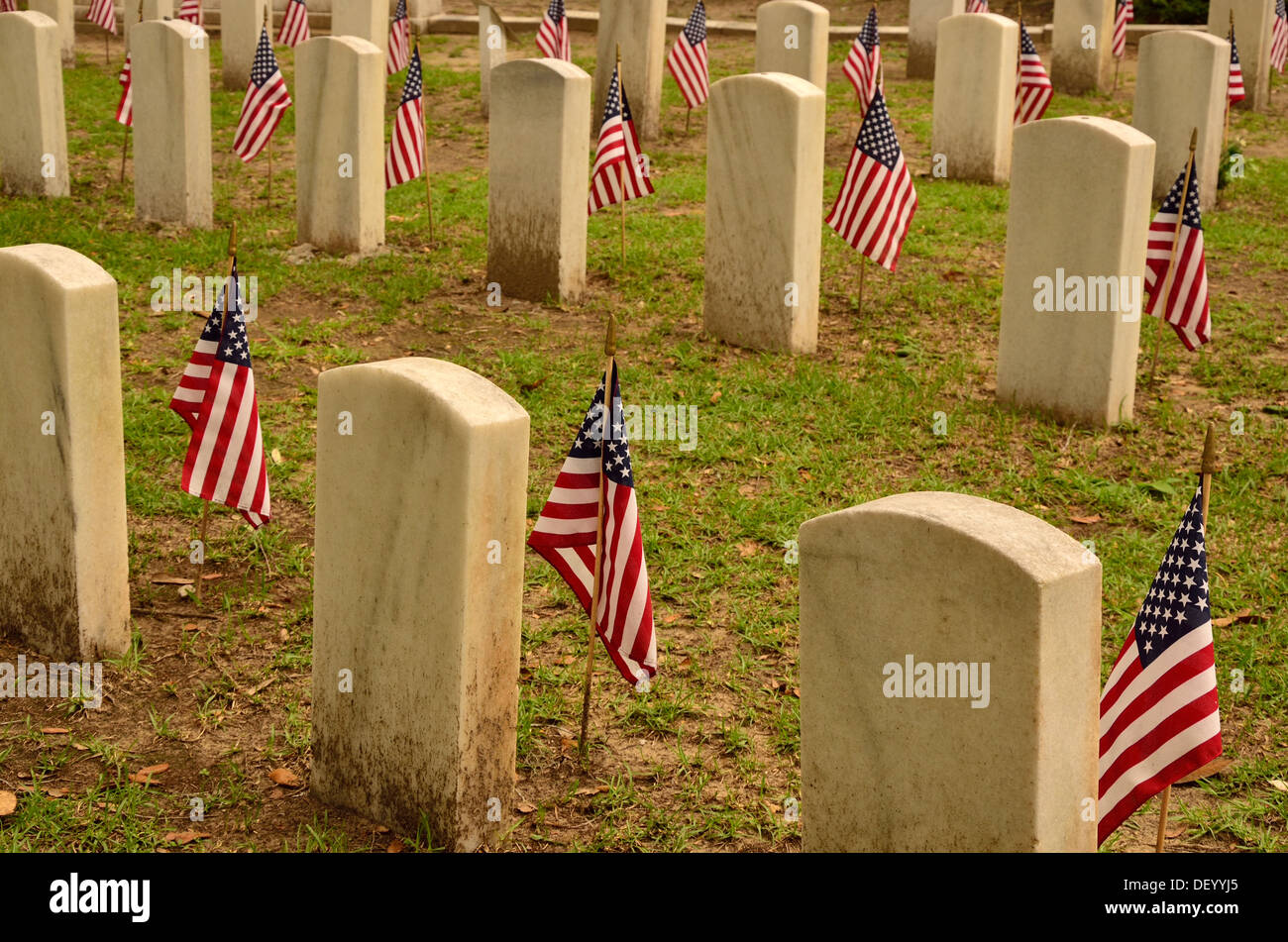Rows of veterans' tombstones honored with an American flag for each ...