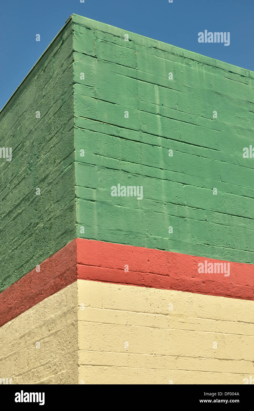 Boldly blocked paint colors of green red and tan on old building Stock ...