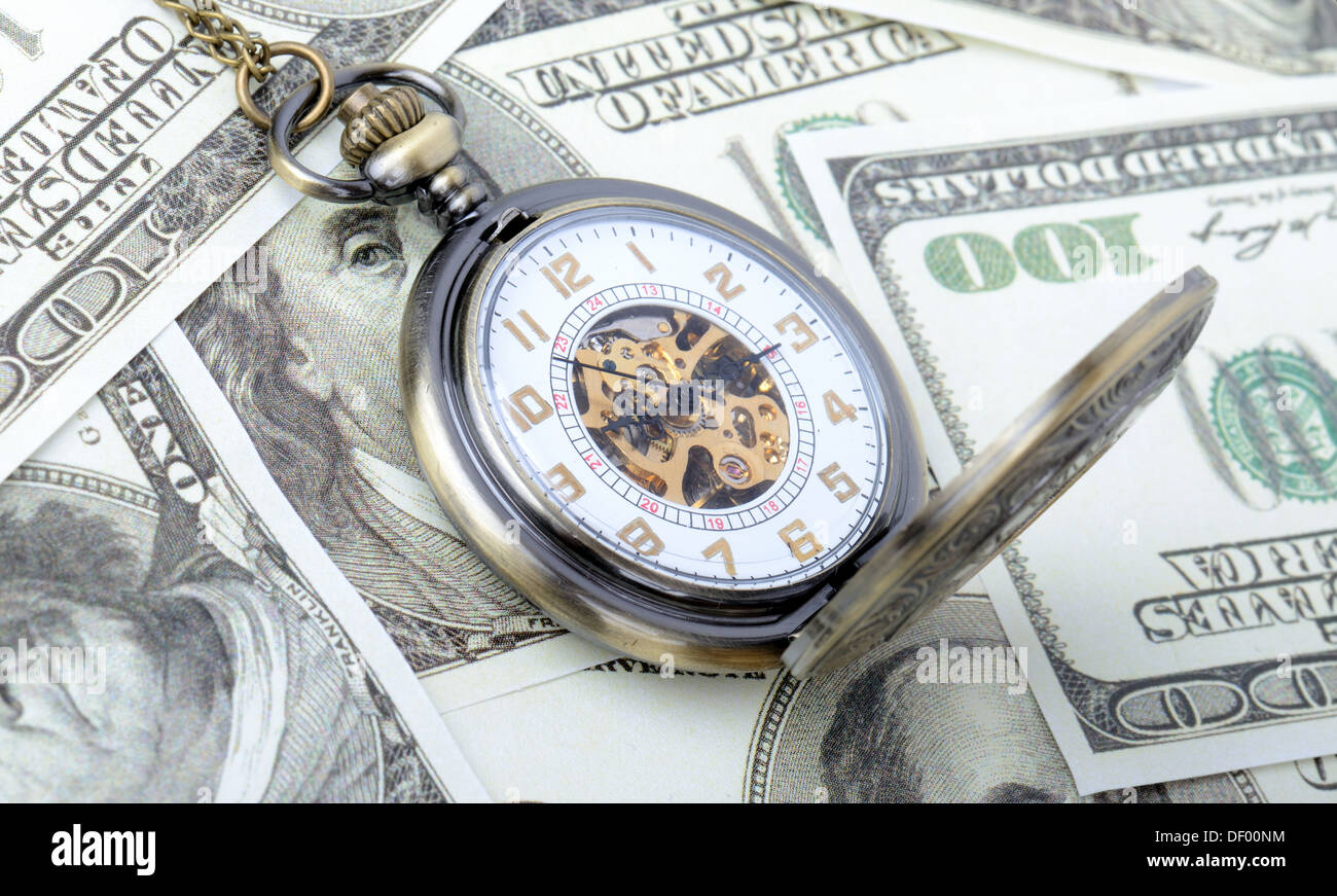 Concept of time is money, old watch on a pile dollar notes Stock Photo ...