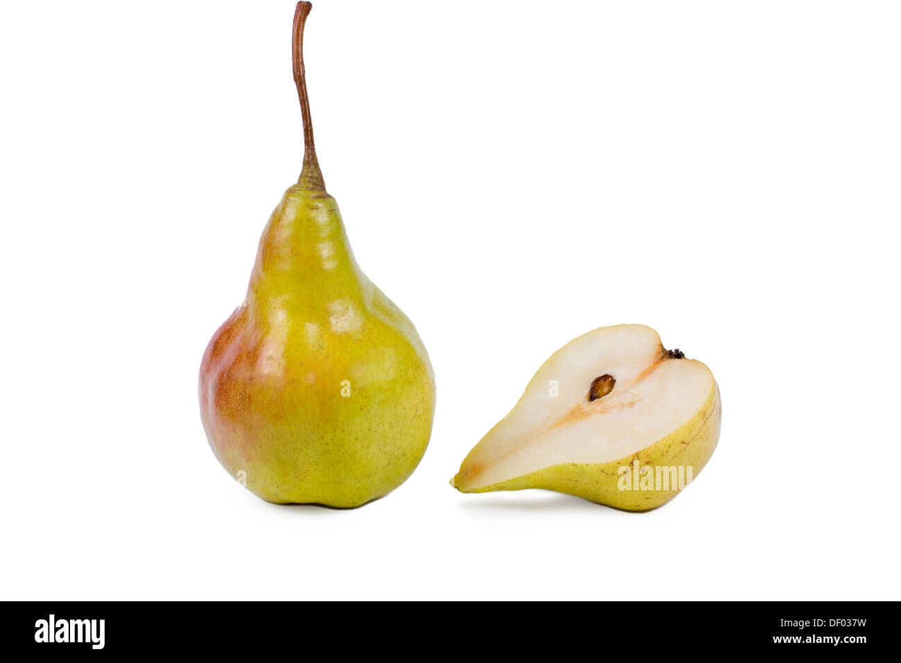 Whole and halved fresh pear cut longitudinally to show the core and ...