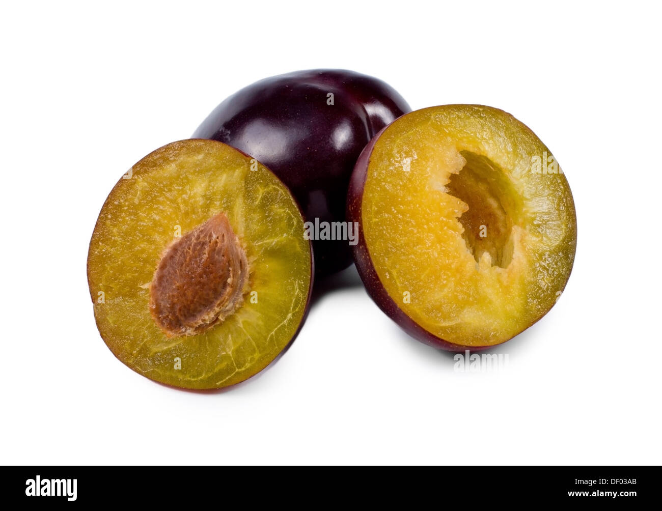 Closeup view of the two halves of a fresh purple plum showing the ...