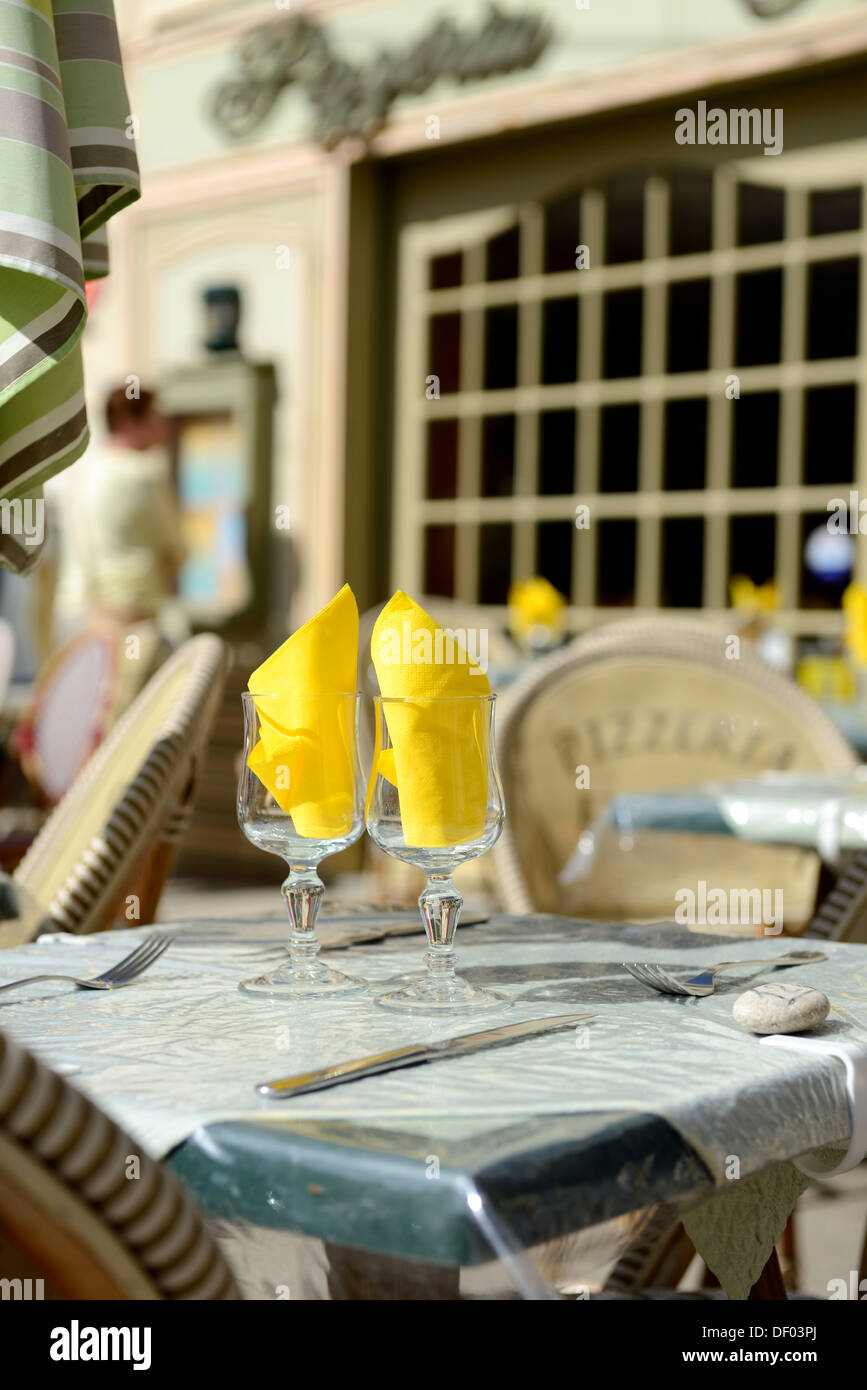 tables ready at a restaurant Pizzeria customer viewing menu in ...