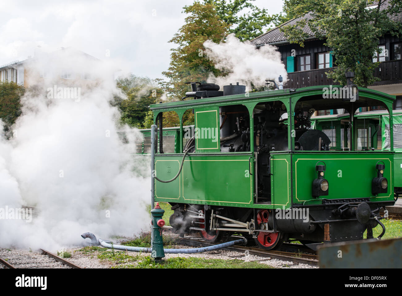 Old steam locomotive vintage running gear with steam smoke running as a ...