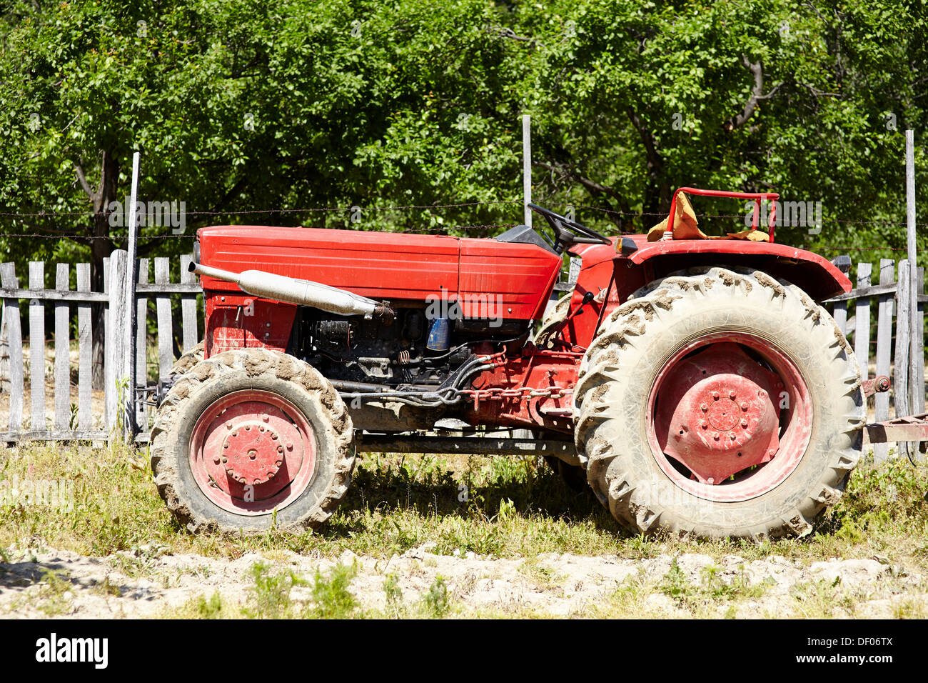 Old red tractor in an orchard in the daylight Stock Photo - Alamy